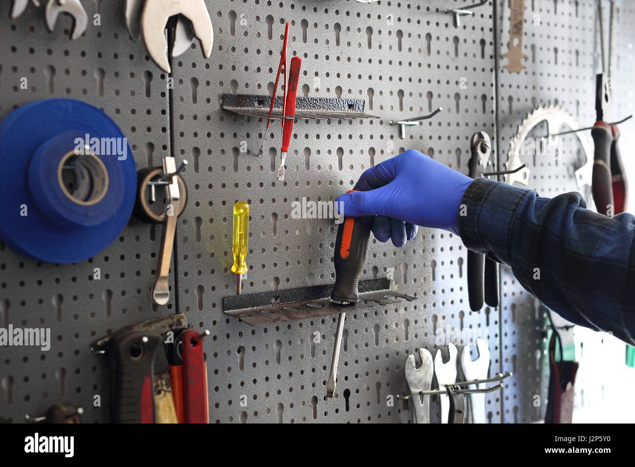 Screwdriver, mechanic takes a screwdriver from the workshop Stock Photo ...
