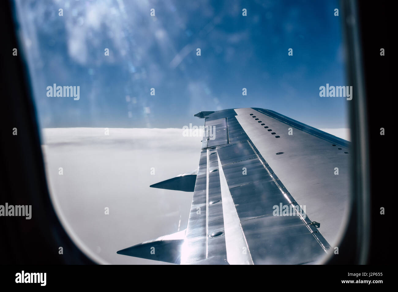 Airplane wing in sky Stock Photo - Alamy