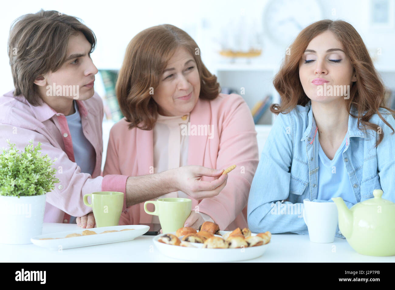 Happy family drinking tea together Stock Photo - Alamy