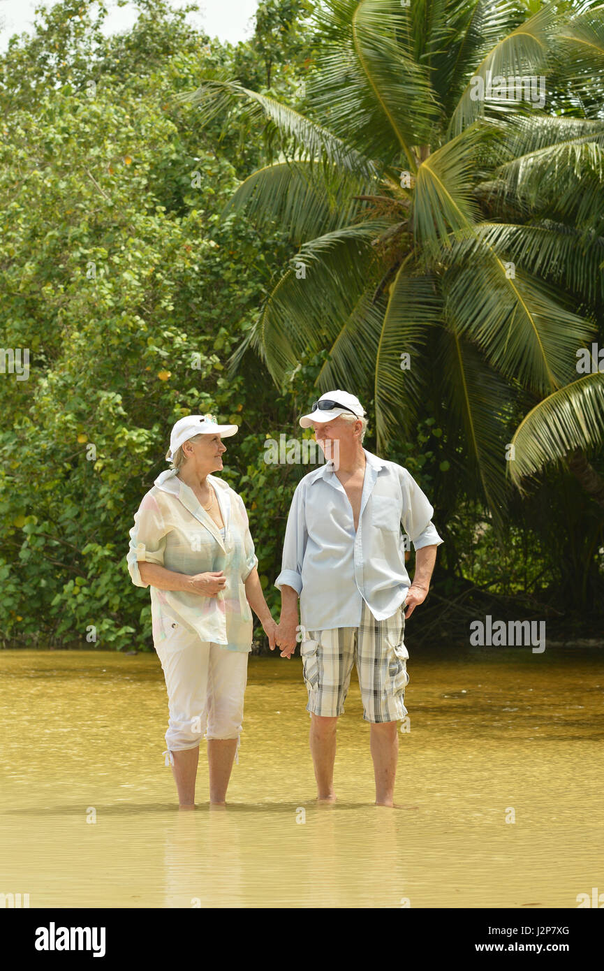 Elderly couple rest at tropical resort Stock Photo - Alamy