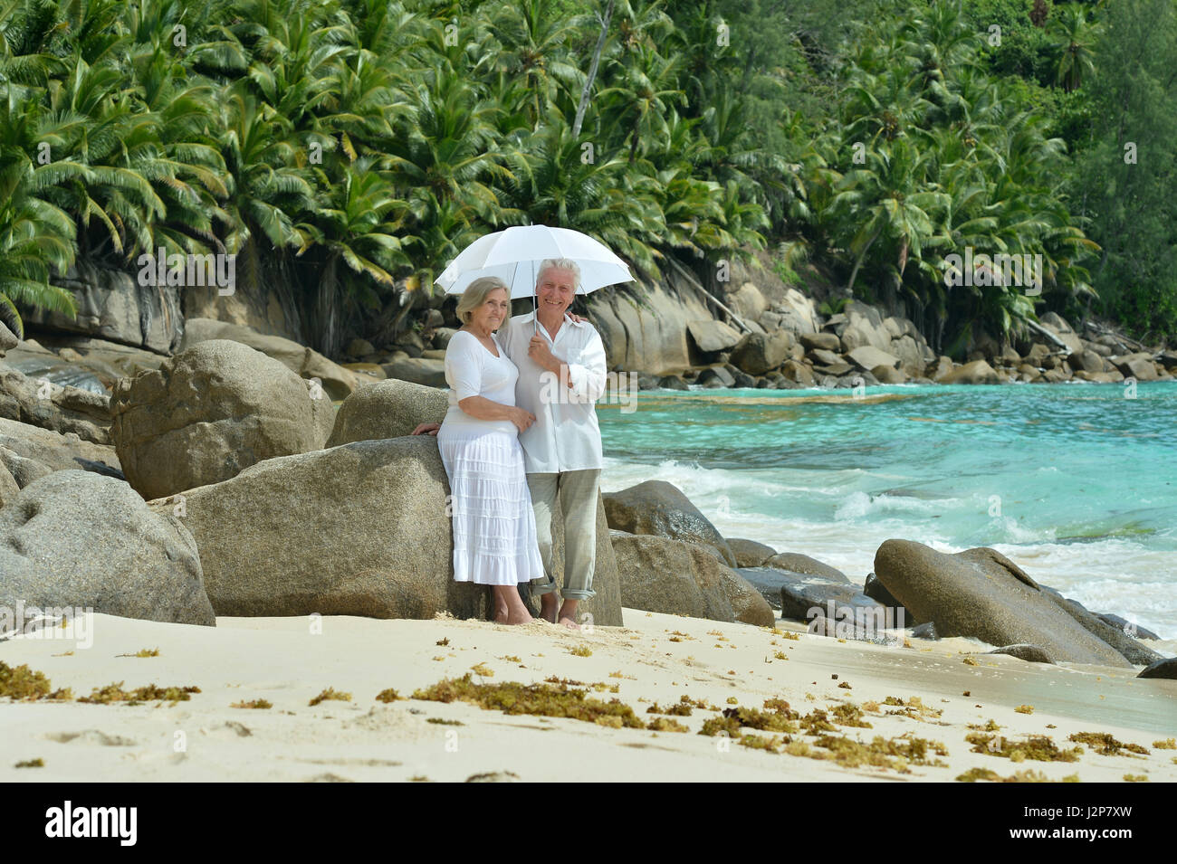 Elderly couple rest at tropical resort Stock Photo - Alamy