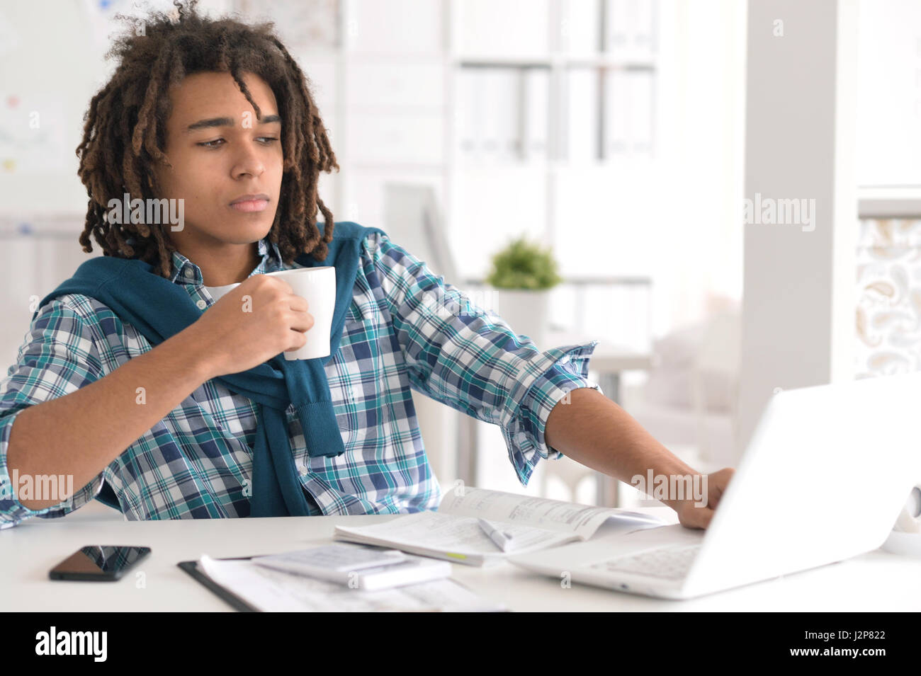 Young business man with laptop working Stock Photo - Alamy