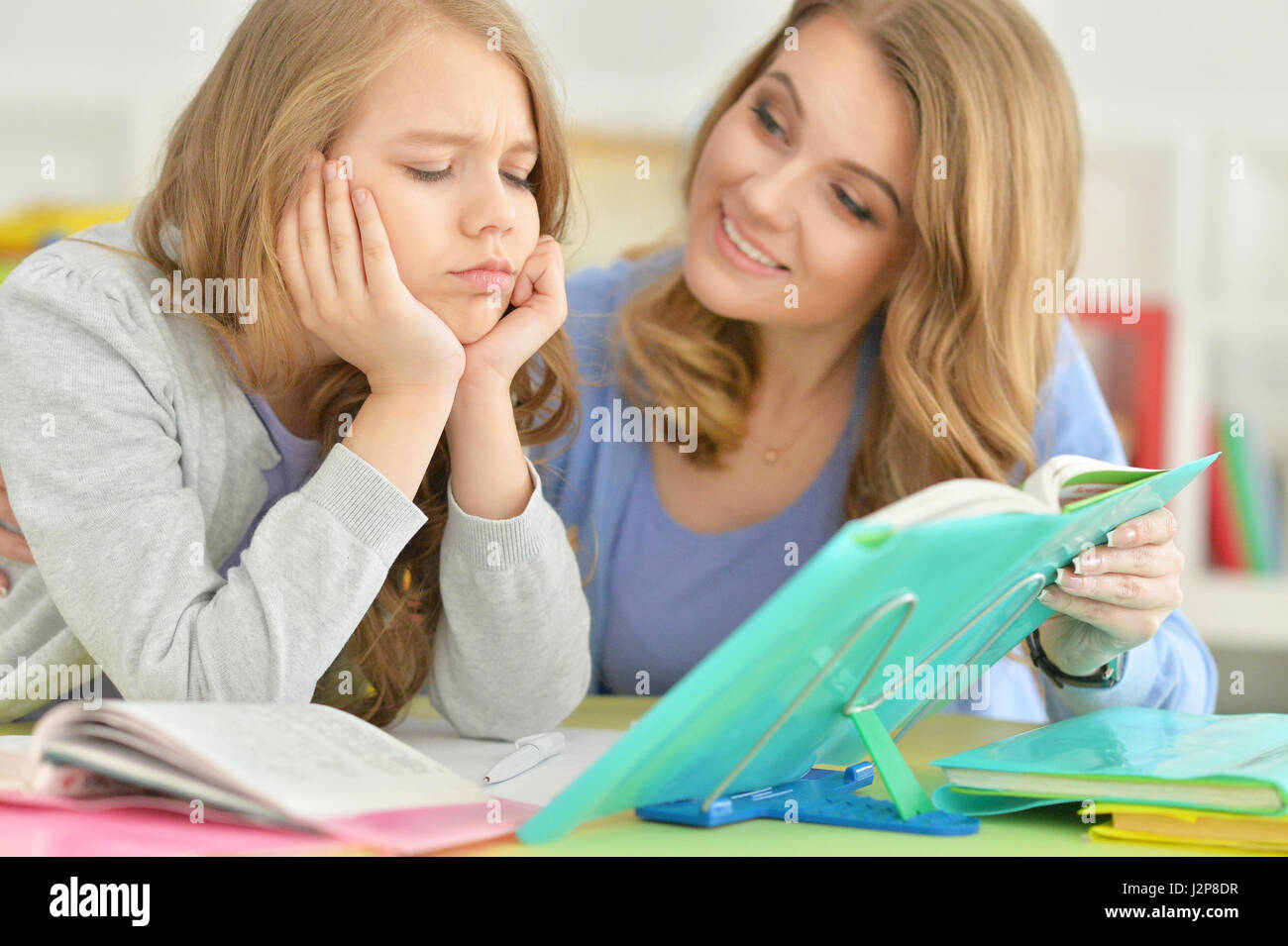 Mother and daughter study Stock Photo - Alamy