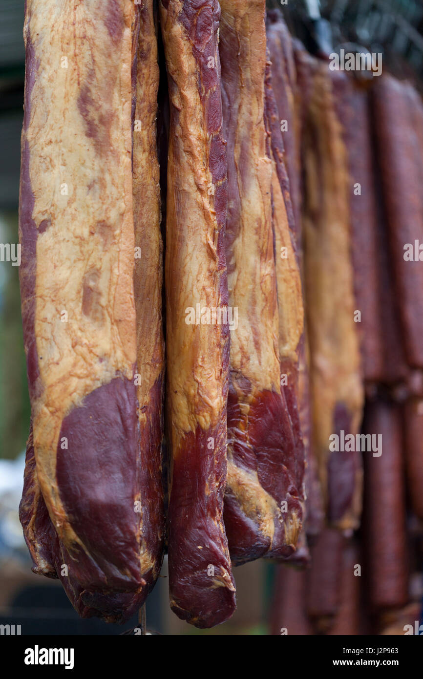 Very tasty home made smoked dried meat hanging on the pole, selective ...