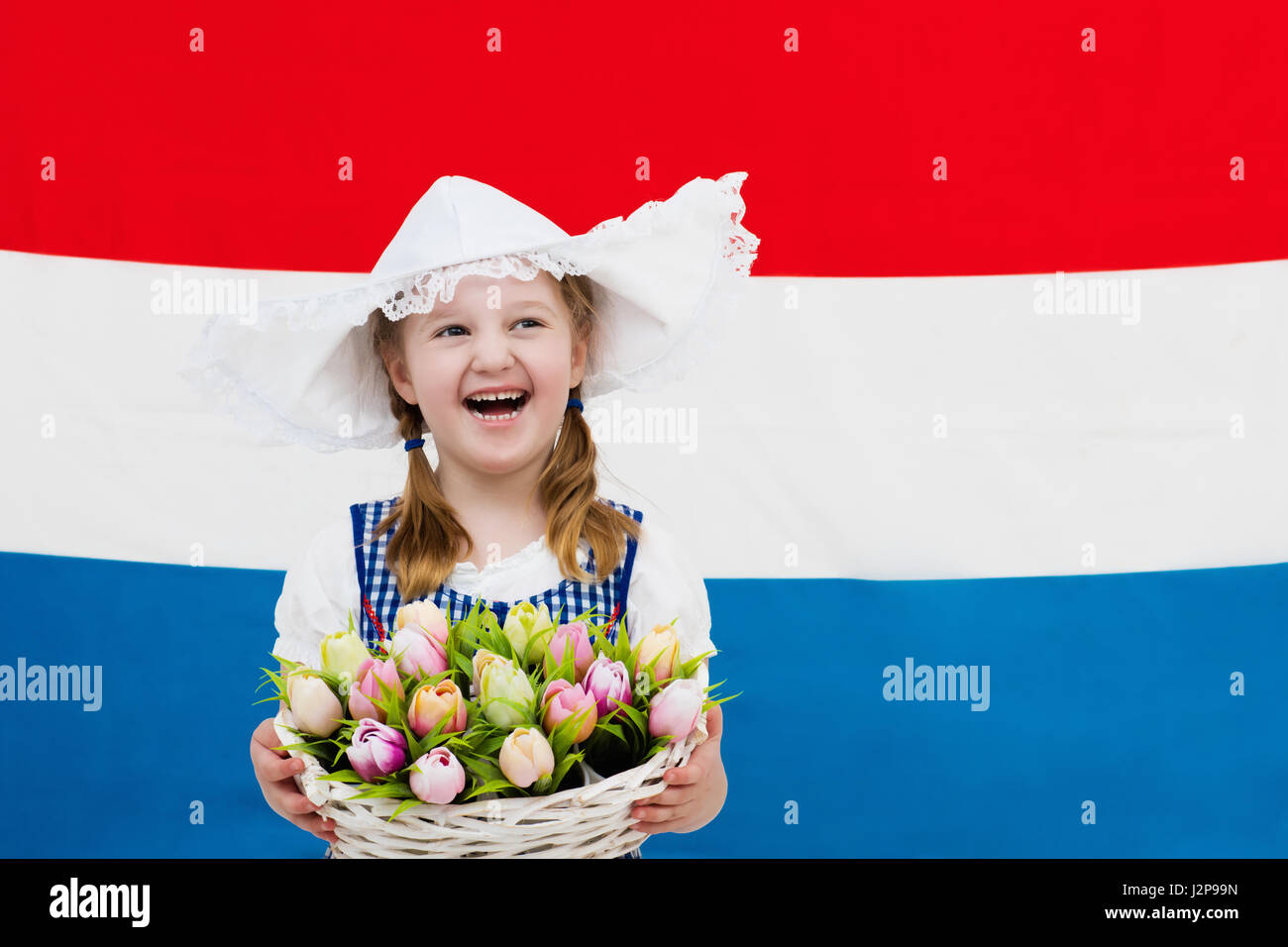 Little Dutch girl wearing traditional national costume, dress and hat ...