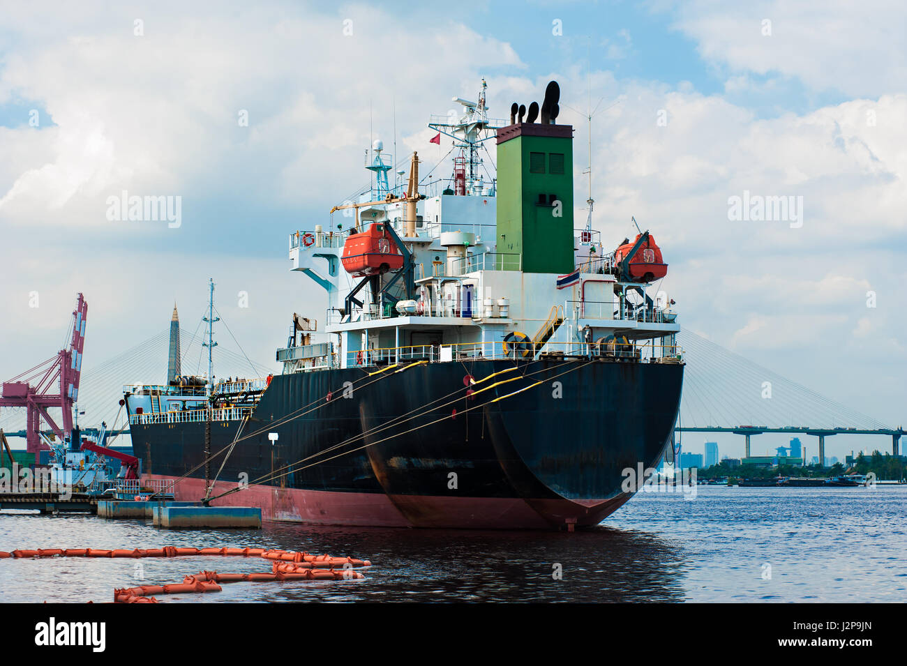 Logistic concept, black Ship parked in the river. Waiting to dock and ...