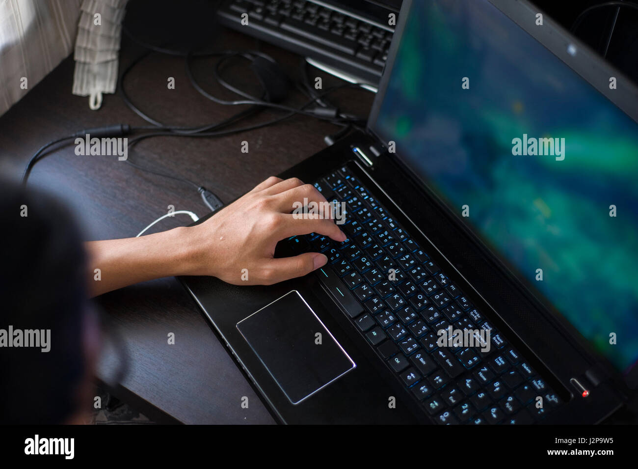 Image of blurred back head view of concentrated Asian Gamer playing ...