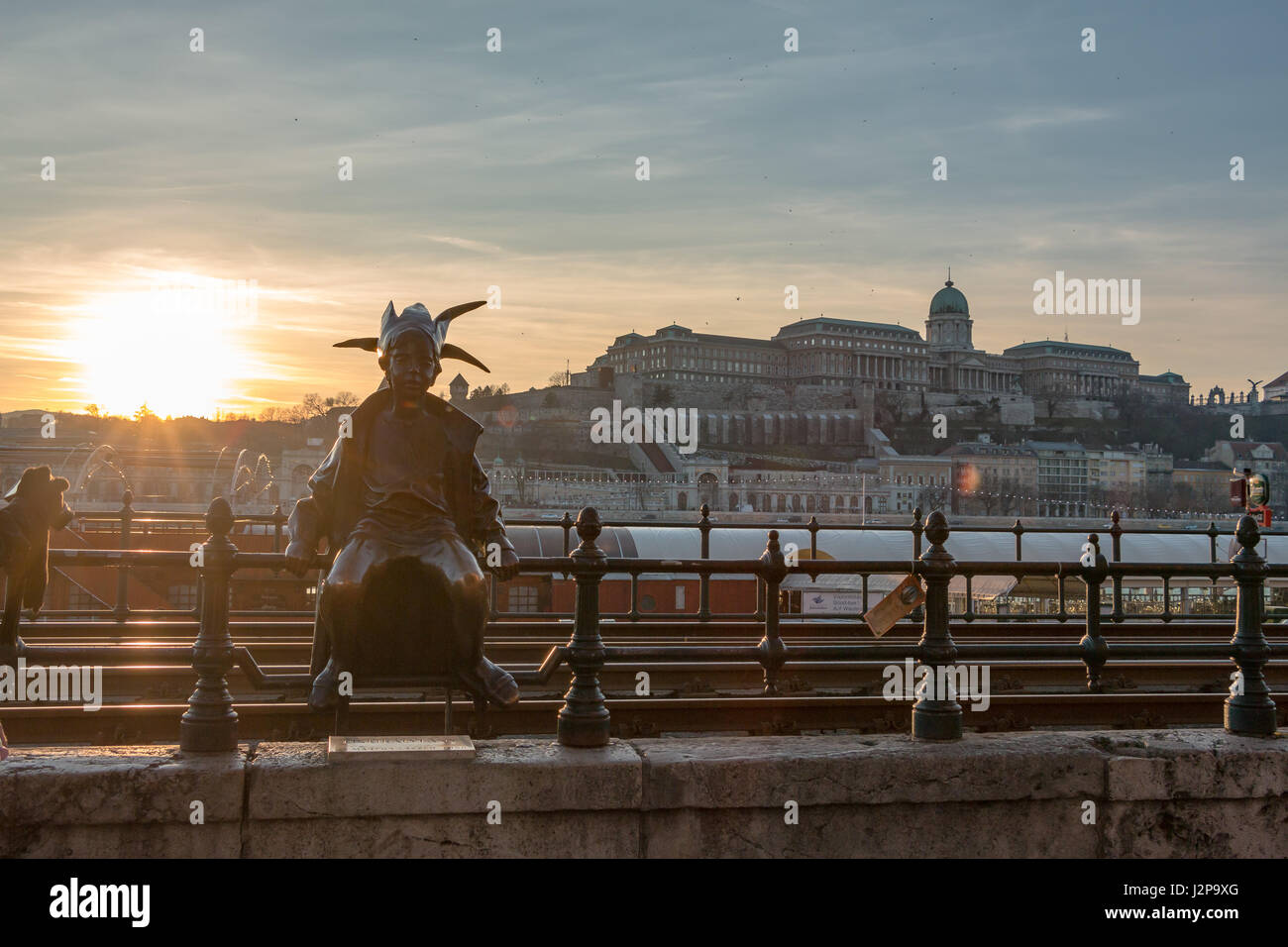The Little Princess Statue with Buda Castle in the background at sunset ...