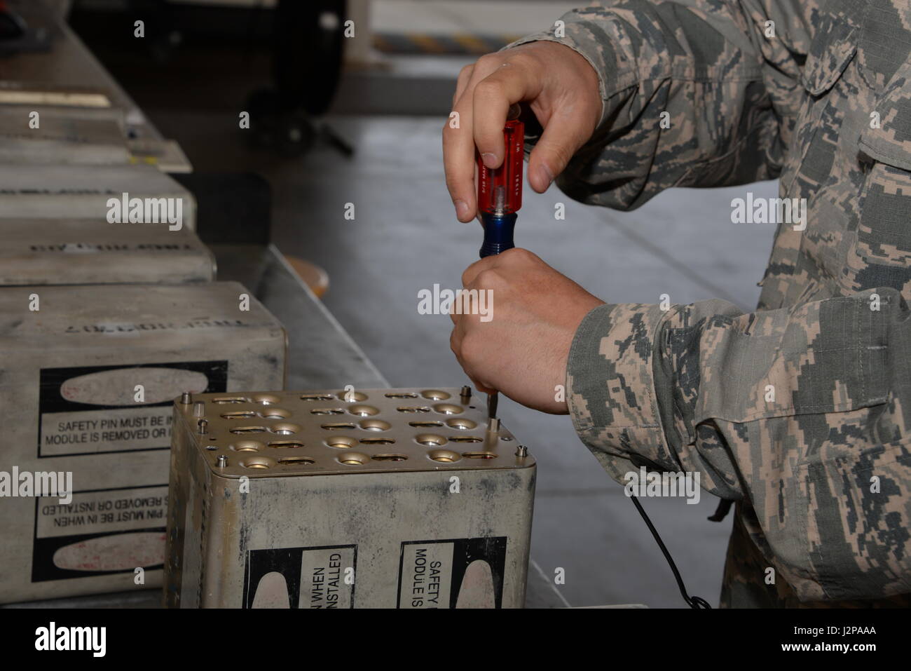 A member of the 60th Maintenance Squadron's Munitions Flight carefully ...