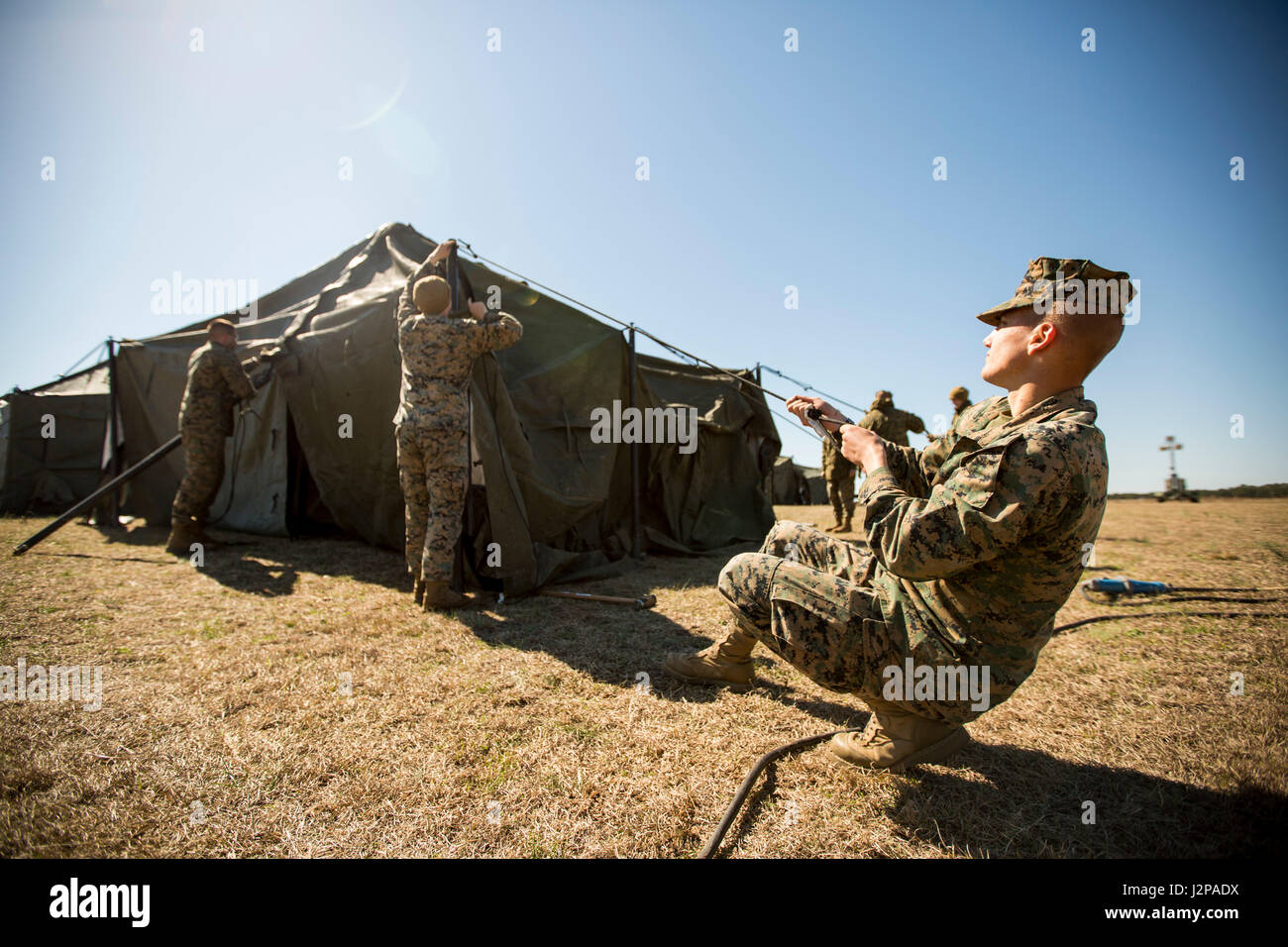 U.S. Marines assigned to Marine Wing Support Squadron 274 set up a tent ...