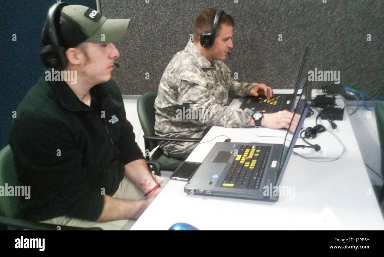 Rob Miller (left), contractor with Booze Allen Hamilton Inc., teaches ...