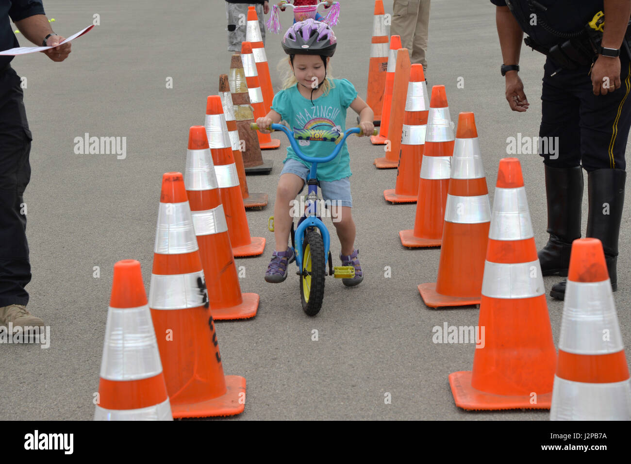 A three-year-old participates in a balance obstacle course during the ...