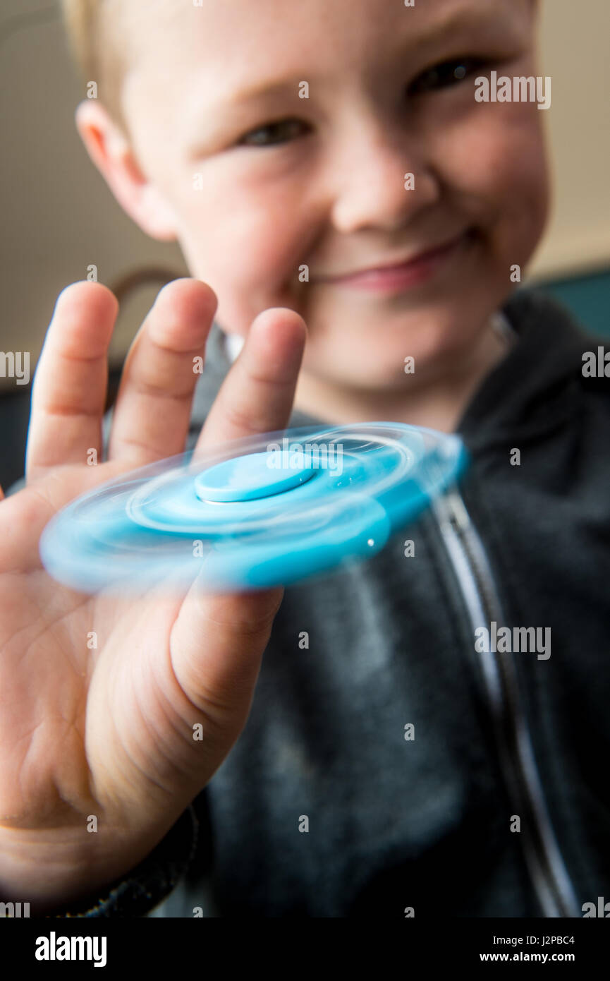 Sunday 30 April 2014 Pictured: A young boy uses a bright blue fidget ...