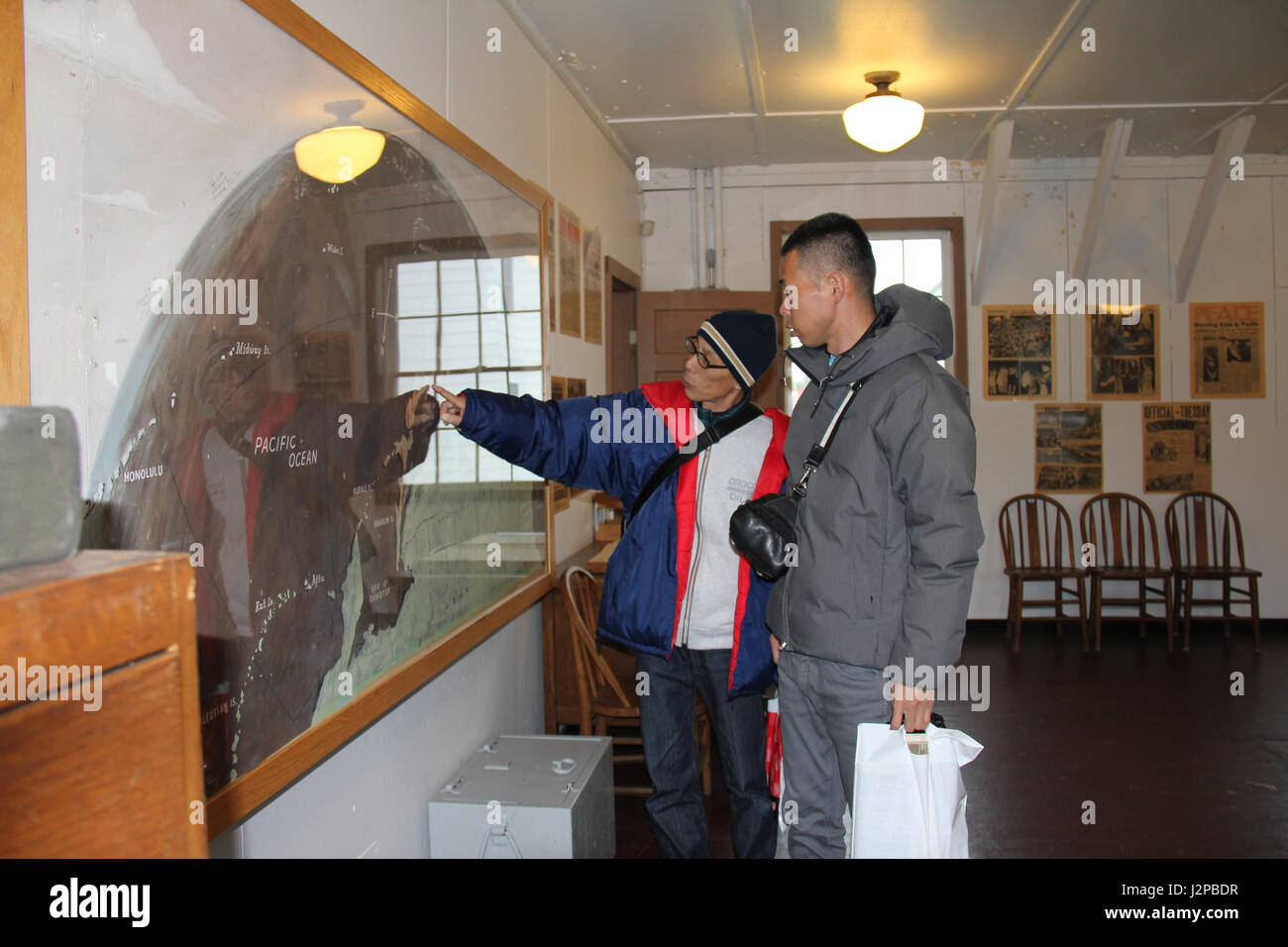 Visitors from Japan view a World War II map at Fort McCoy depicting the ...