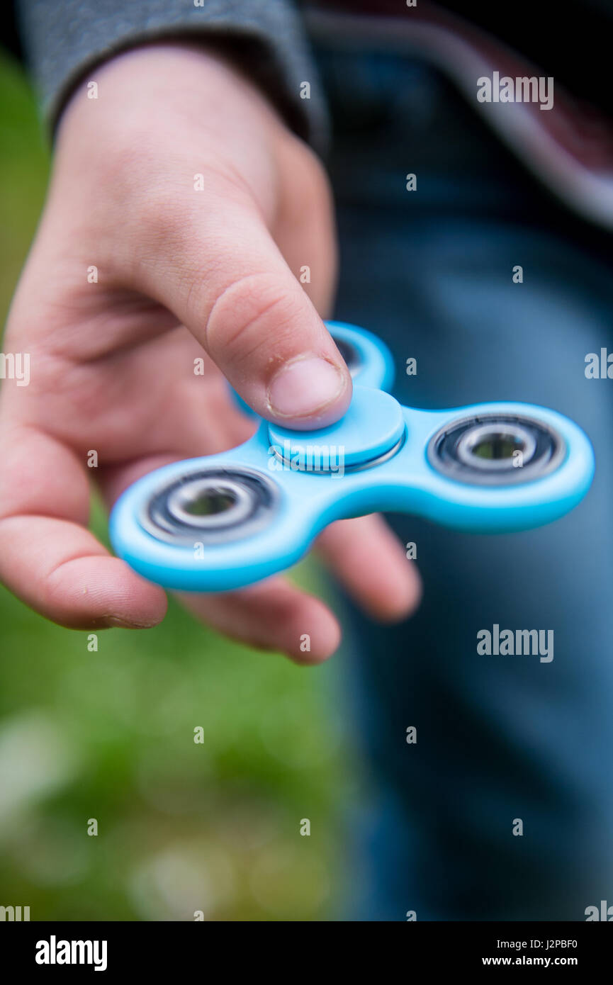 Sunday 30 April 2014 Pictured: A young boy uses a fidget spinner Stock ...