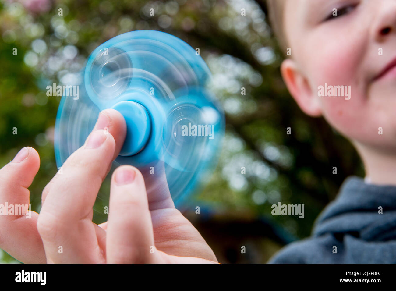 Sunday 30 April 2014 Pictured: A young boy uses a fidget spinner Stock ...