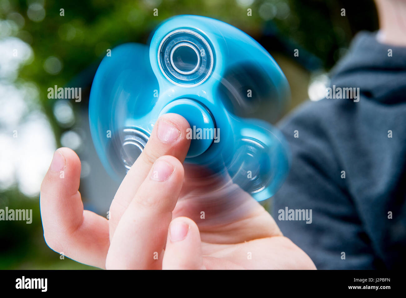 Sunday 30 April 2014 Pictured: A young boy uses a fidget spinner Stock ...