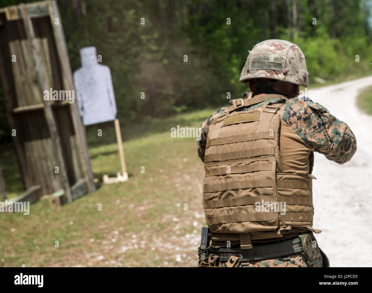 A Marine engages a stationary target during a timed sniper course ...