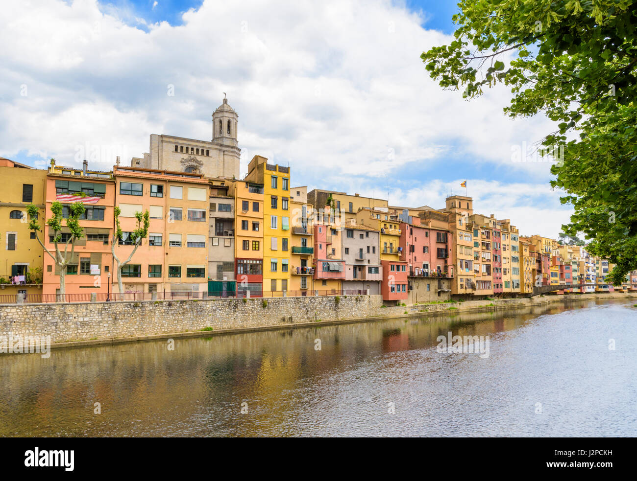 The banks of the River Onyar with the cathedral belltower towering over ...