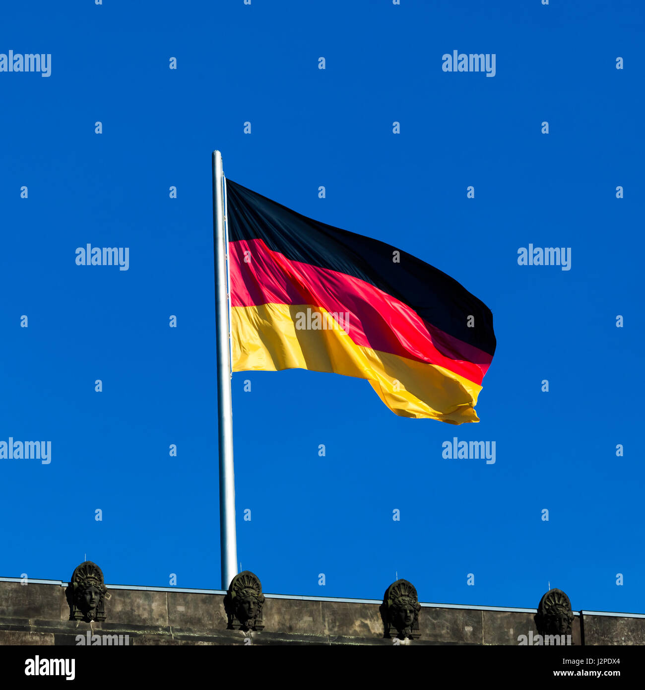 Silky flag of Germany flying in the wind. German flag on the top of ...