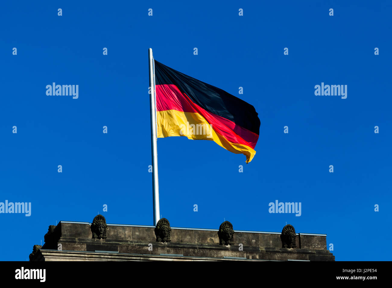 Silky flag of Germany flying in the wind. German flag on the top of ...