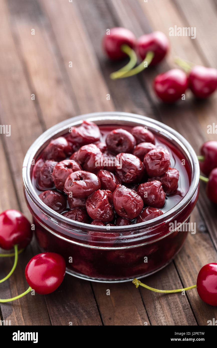 Berries cherry with syrup in a glass jar. Canned fruit Stock Photo - Alamy
