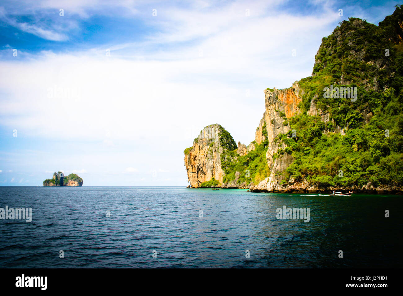 Great and large rocks in the ocean. Small islands with green forest and ...