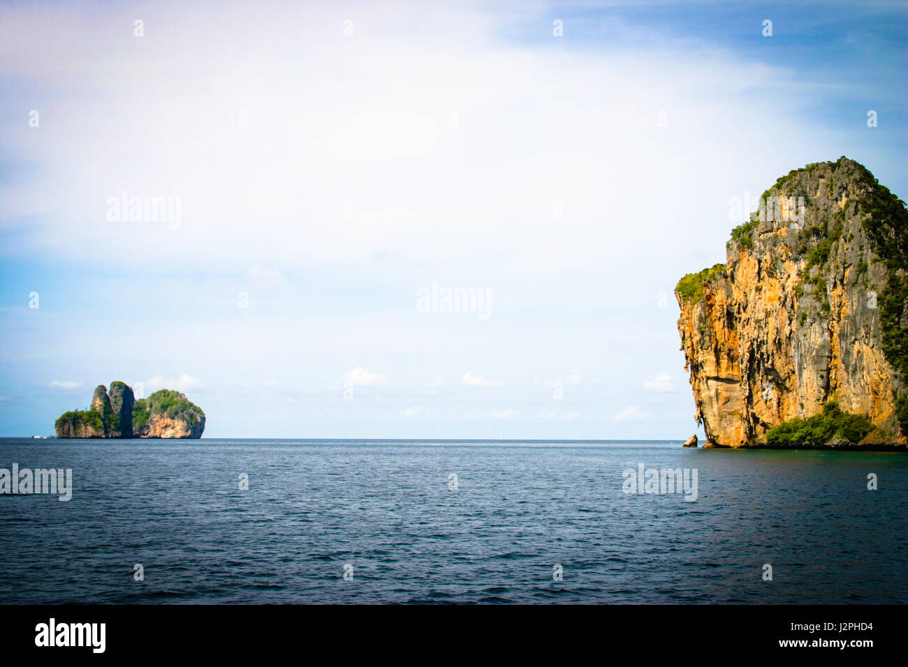 Great and large rocks in the ocean. Small islands with green forest and ...
