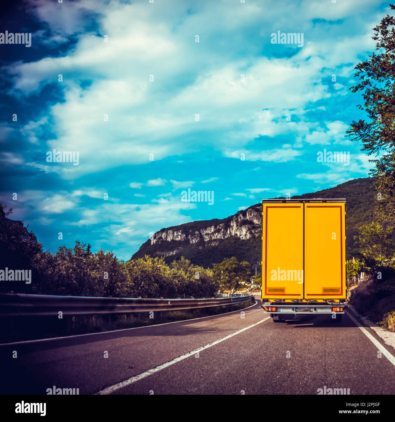 truck on road. cargo transportation. Yellow truck Stock Photo - Alamy