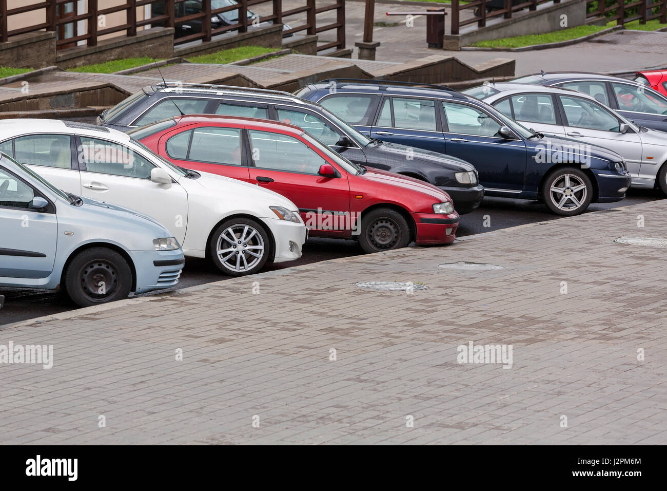 row of diagonally parked cars in the city street in a parking lot Stock ...