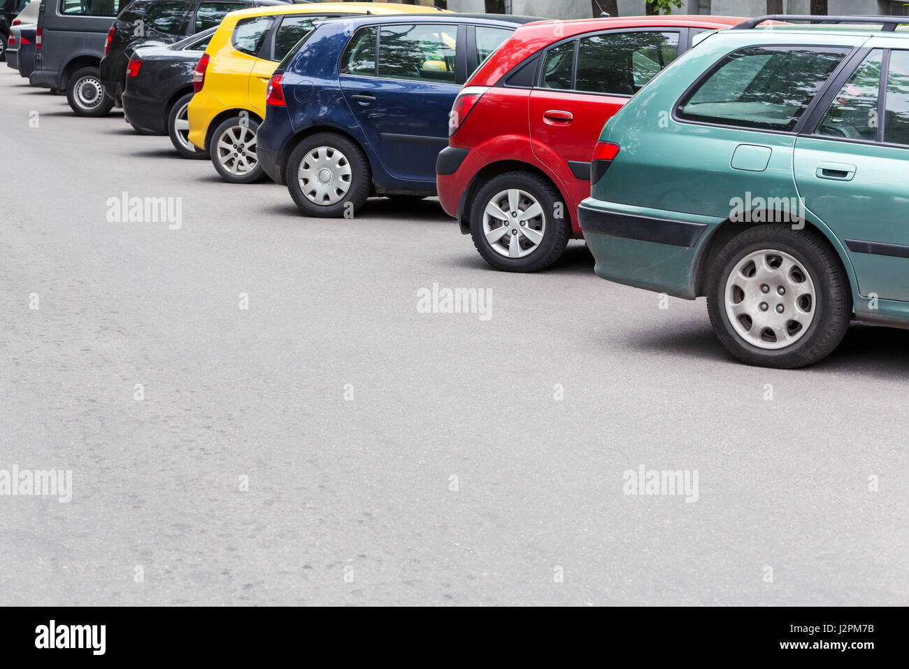 several multicolored cars parked diagonally at parking lot in the ...