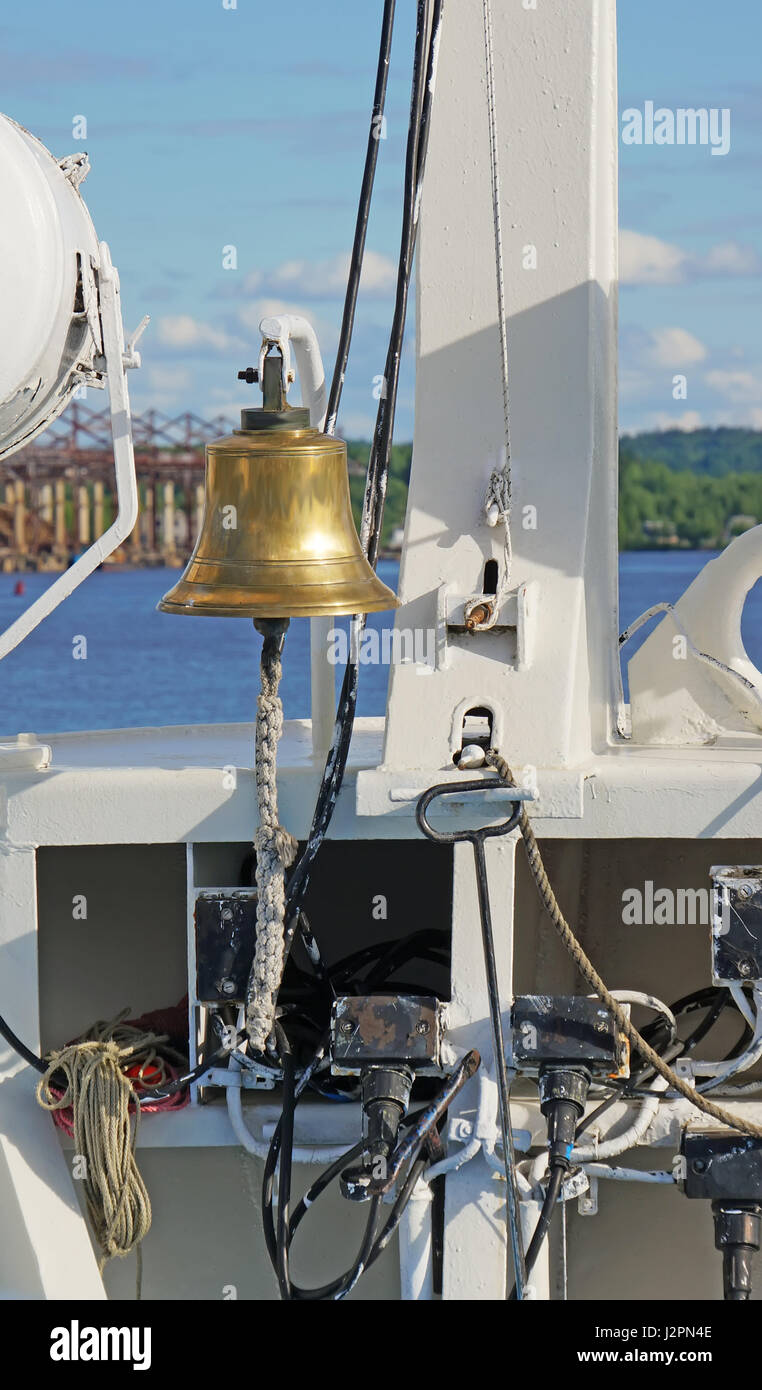 The ship's bell on the bow with elements of the rigging of the ship on ...