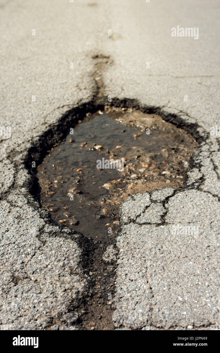Asphalt road hole damage, close up of damaged driveway Stock Photo - Alamy