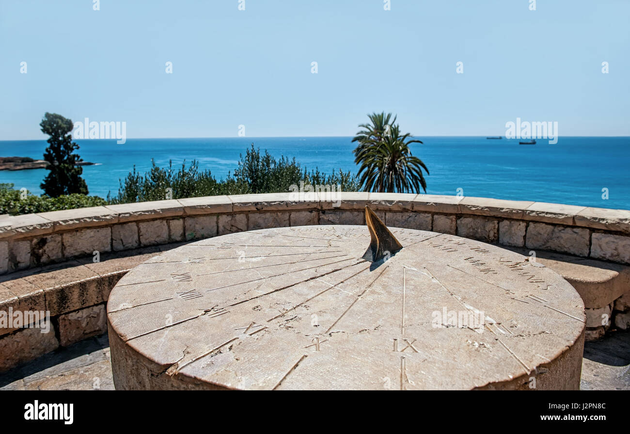 Roman sundial vintage large round stone on a hill above the sea in ...
