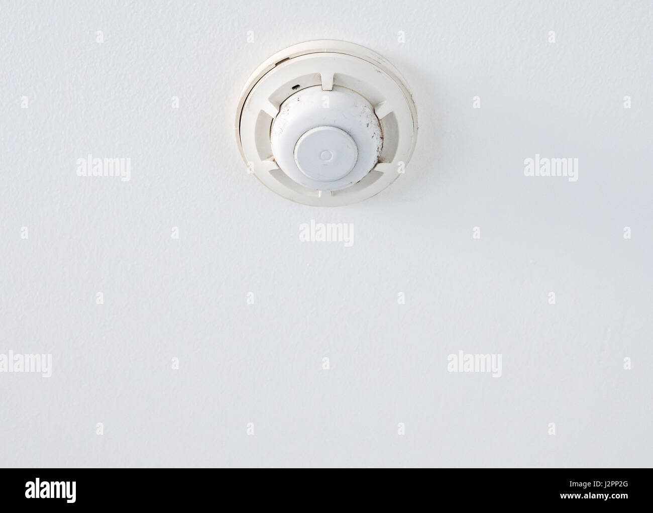 Smoke detector with copy space on the ceiling of the office building ...