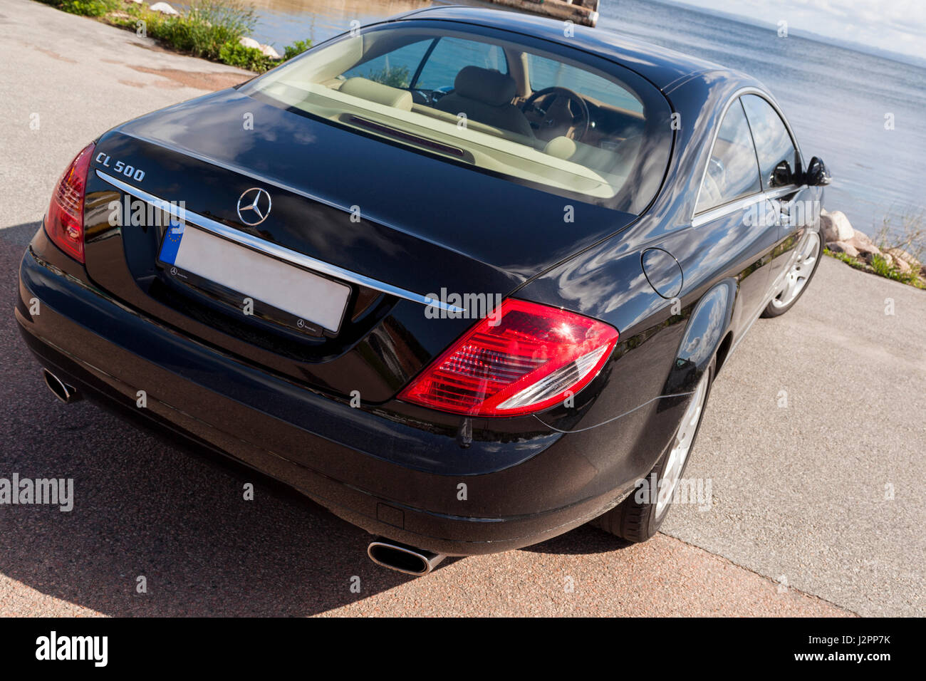 Luxury black Mercedes Benz CL 500 sedan car parked by water in harbour ...