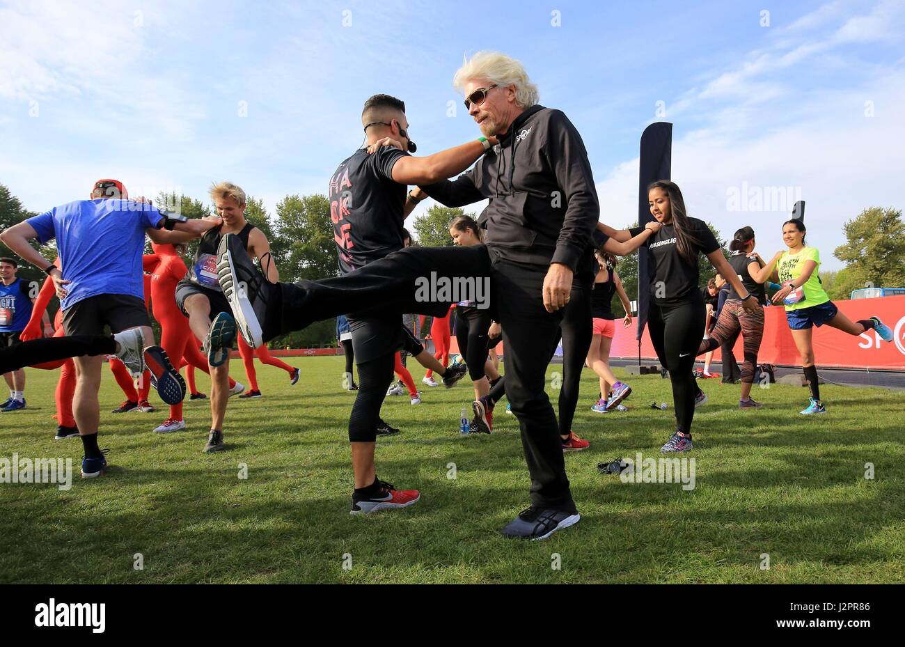 Sir Richard Branson (centre) takes part in a 'Stretch with Rich' before ...