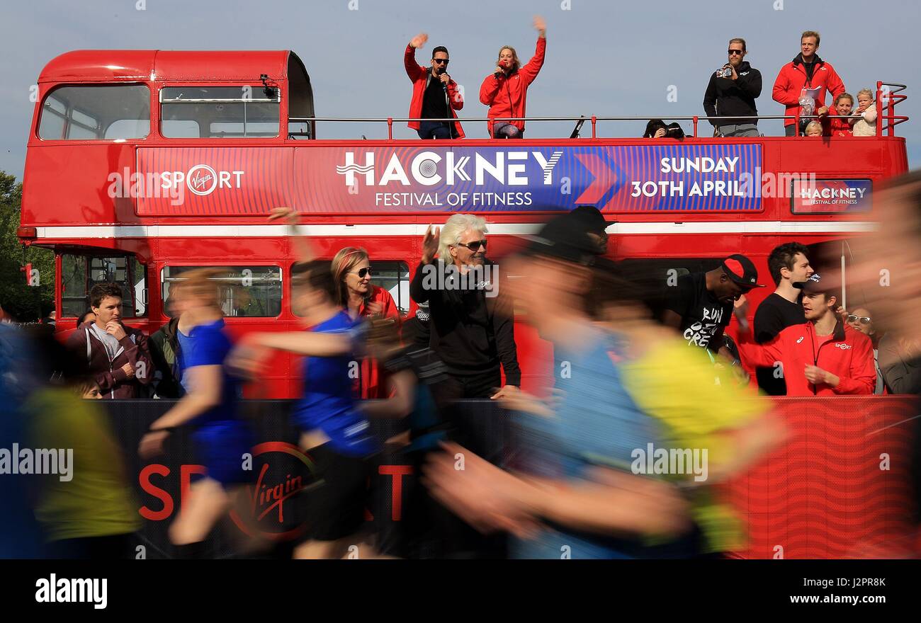 Sir Richard Branson (centre) waves off runners after starting the half ...