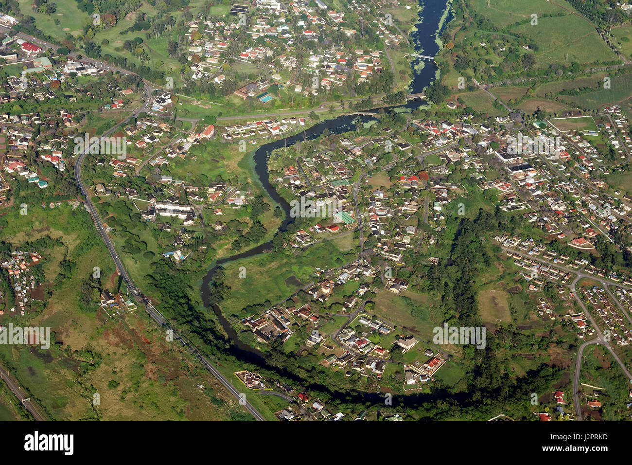 Aerial photograph of an urban settlement surrounded by a green belt and ...