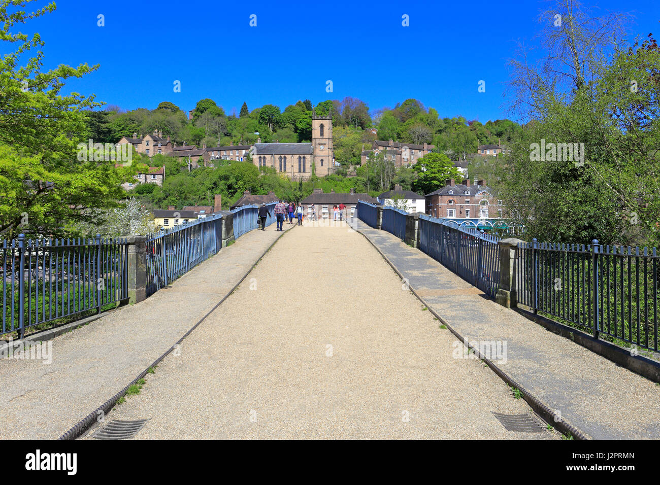 Visitors walking across Iron Bridge at Ironbridge, Shropshire, England ...