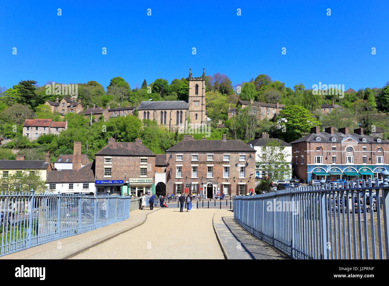 Visitors walking across Iron Bridge at Ironbridge, Shropshire, England ...