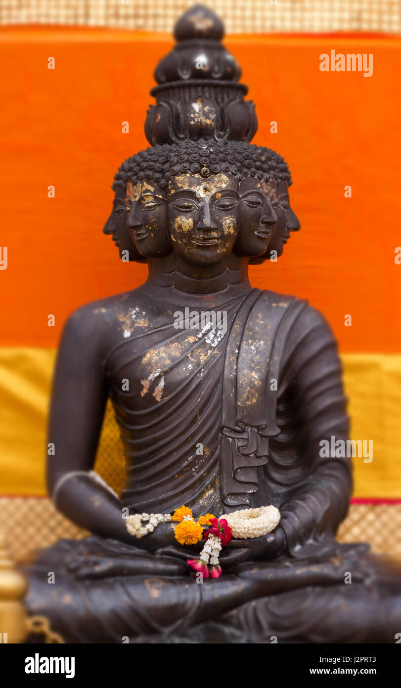 Close-up of meditate Buddha statue with multi faces in soft-focus in ...