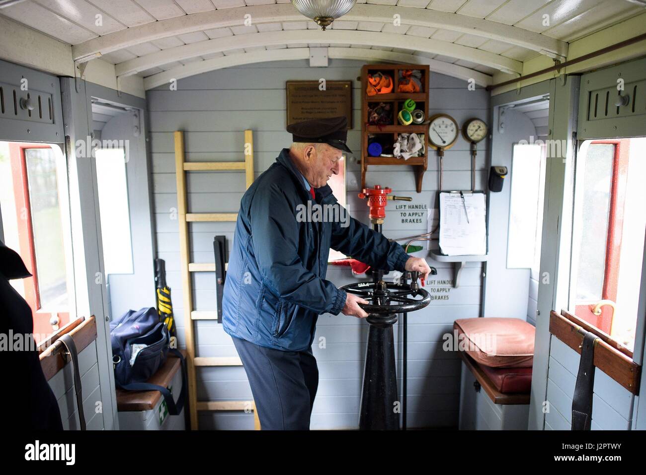 Guard Jim Price releases the handbrake aboard a narrow gauge steam ...