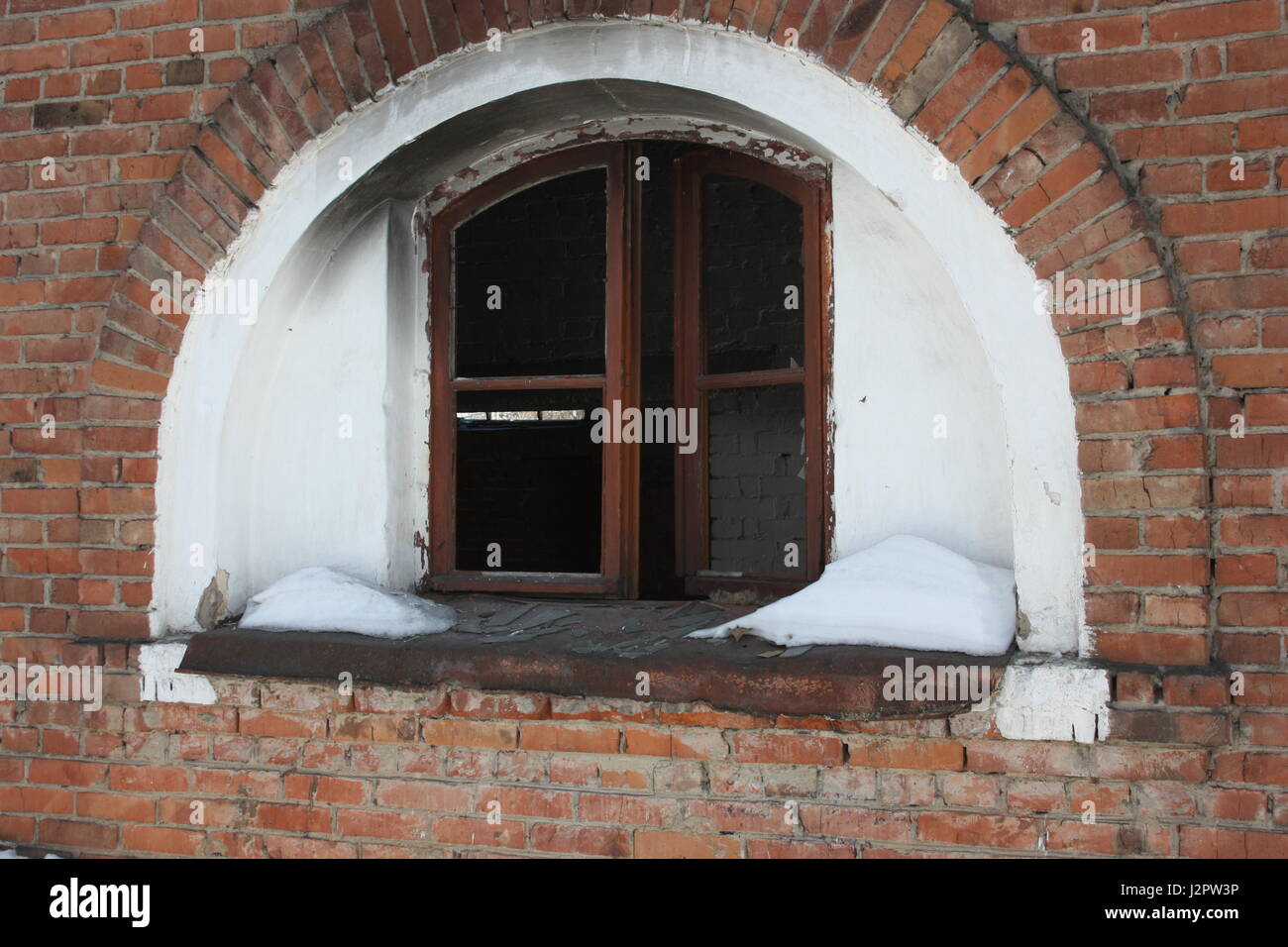 Broken window half arch on red brick wall. Eerie building. . Abandoned ...