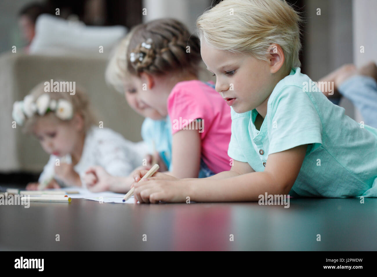 Group of cute children drawing with colorful pencils on floor Stock ...