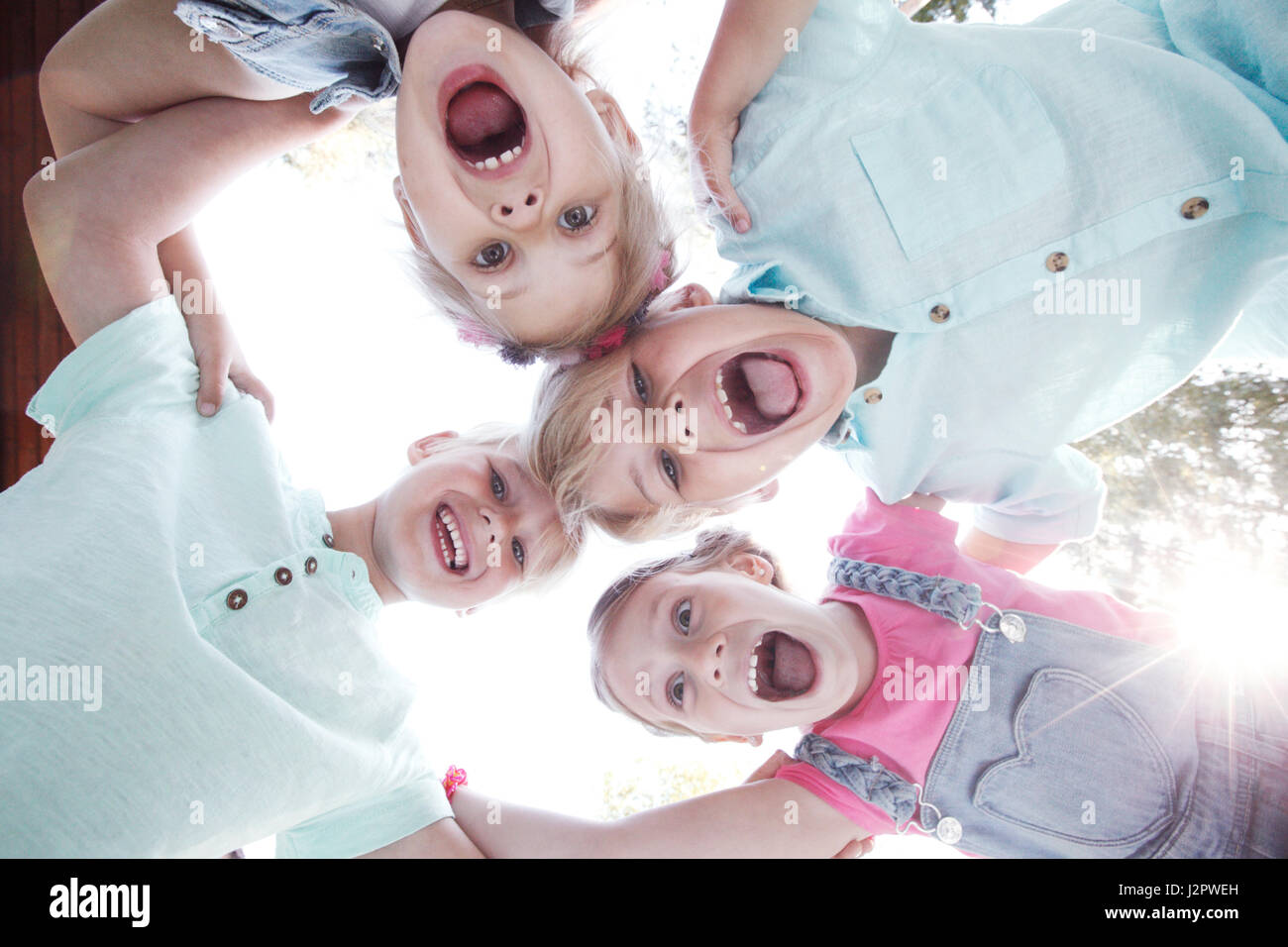 Group of smiling children looking down into camera Stock Photo - Alamy