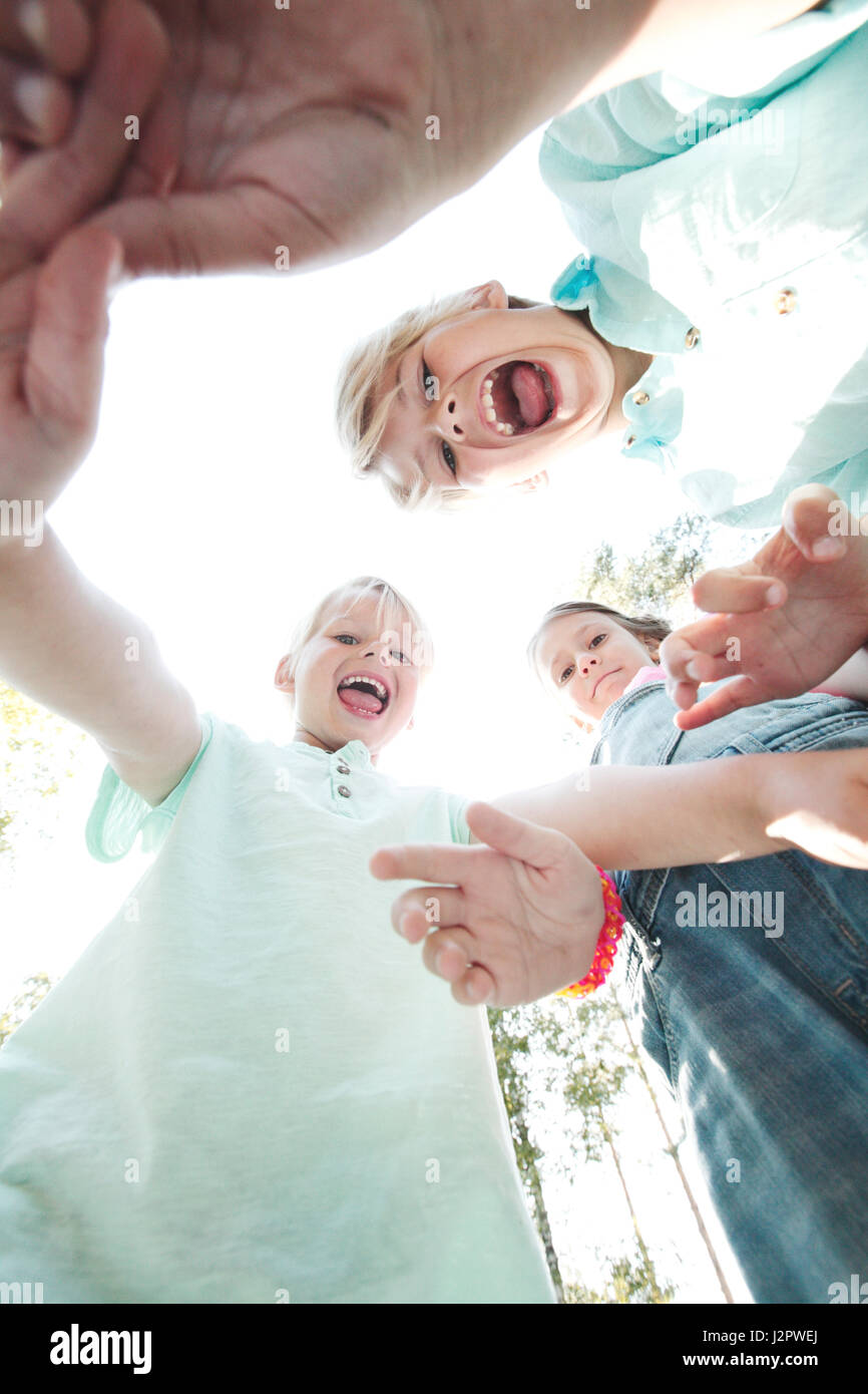 Group of smiling children looking down into camera Stock Photo - Alamy