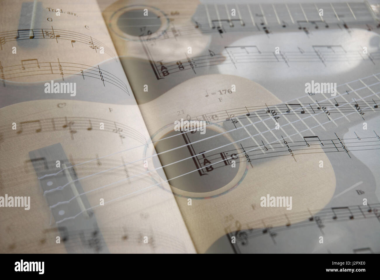 Ukulele and music, in tab and notation. Double exposure Stock Photo - Alamy