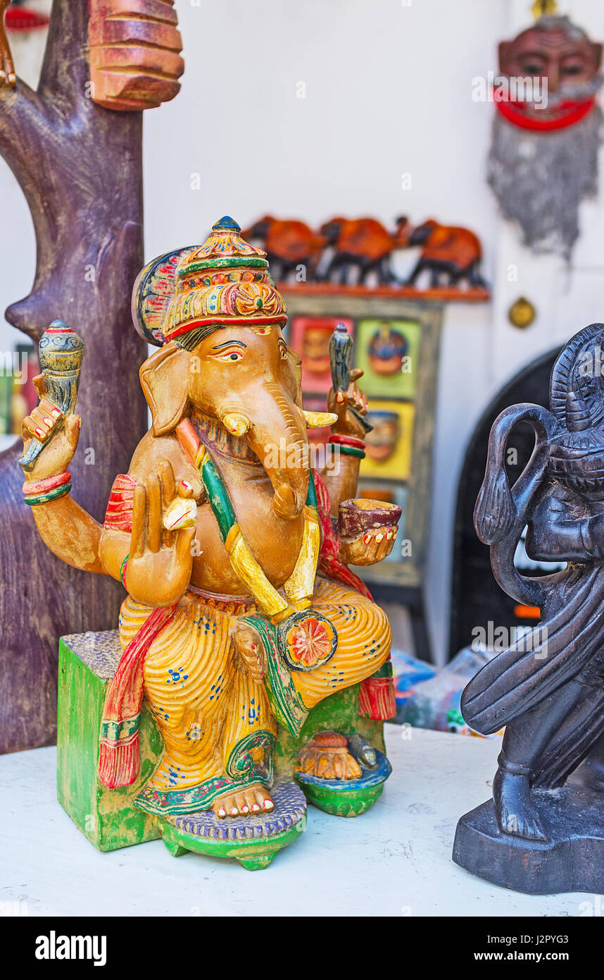 The handmade wooden figurine of Hindu God Ganesha, decorated with ...