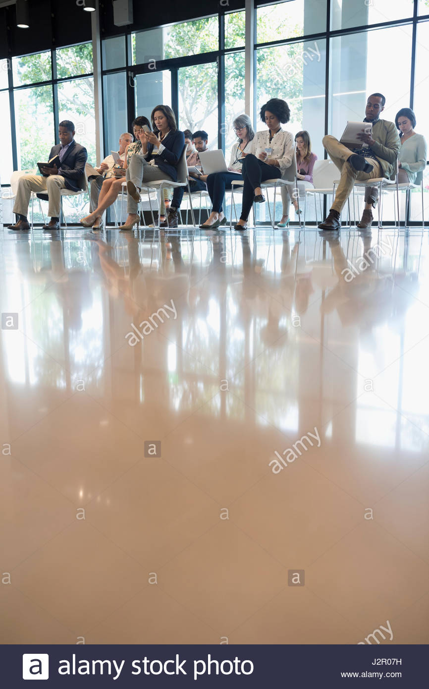 Conference audience taking notes in chairs in office Stock Photo - Alamy